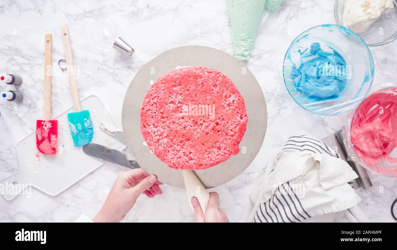 Stacking cake layers to create the round three-layer vanilla cake Stock ...