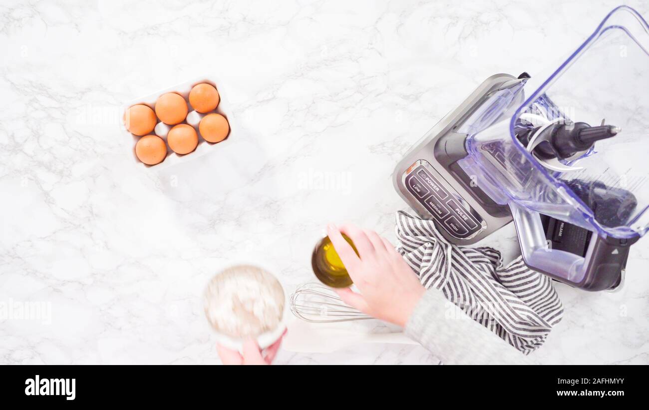 Flat lay. Mixing ingredient in an electric blender to make the crepes ...