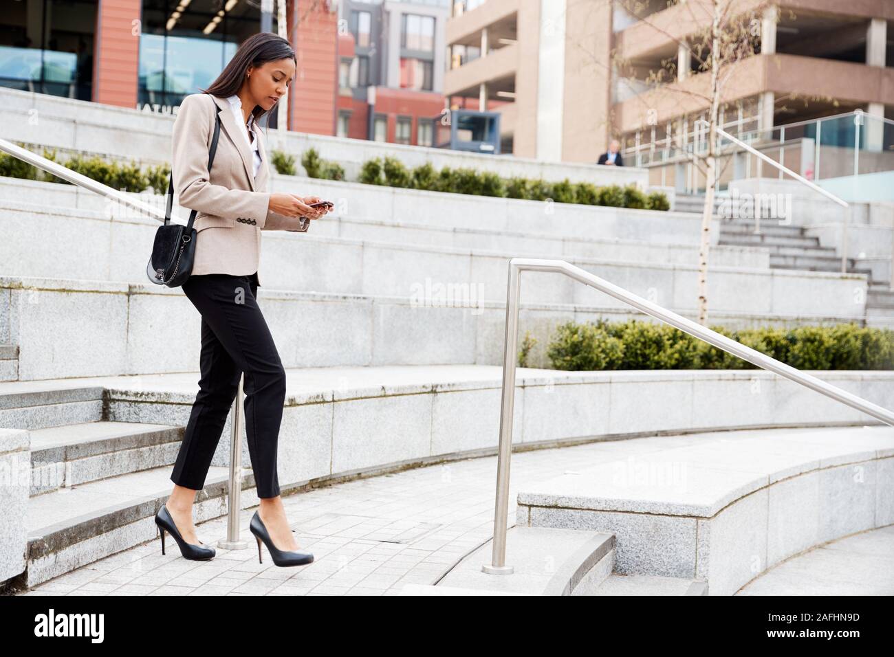 Businesswoman Commuting To Work Checking Messages On Mobile Phone ...