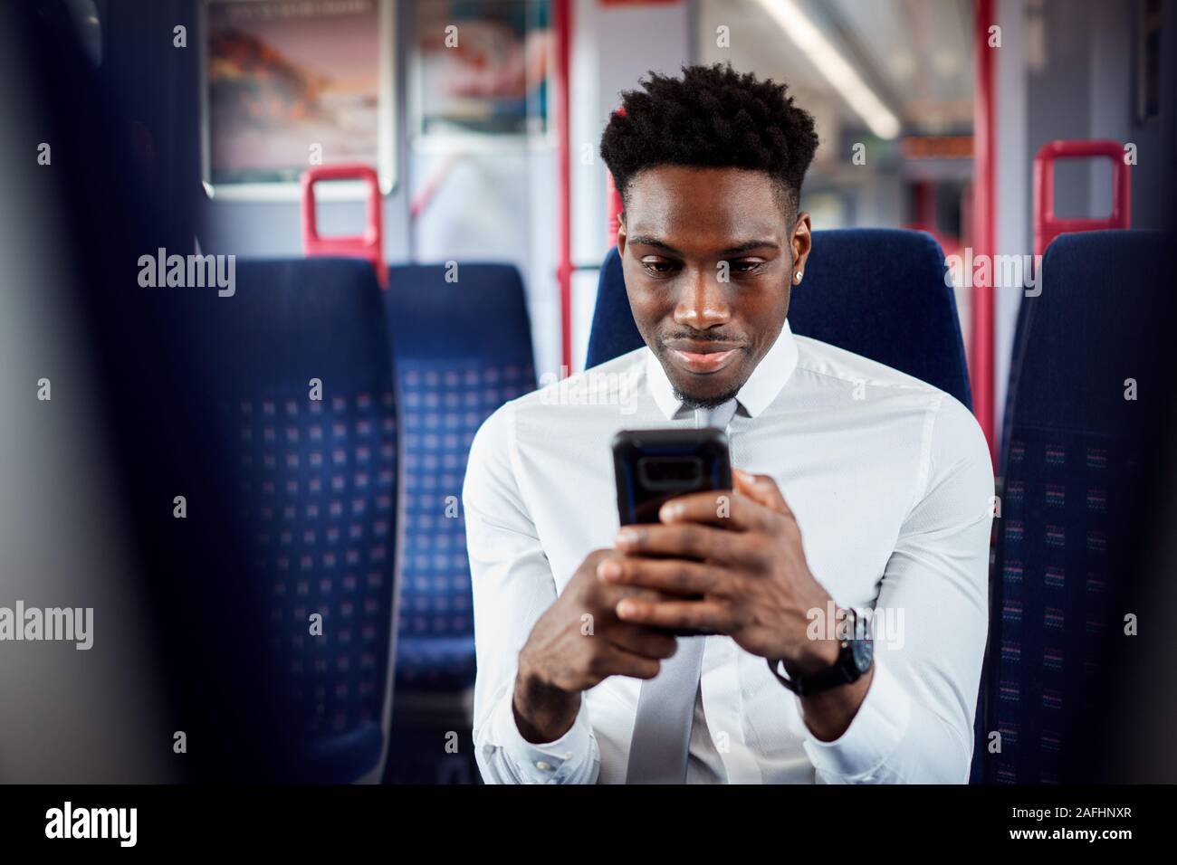 Man on train and phone hi-res stock photography and images - Alamy