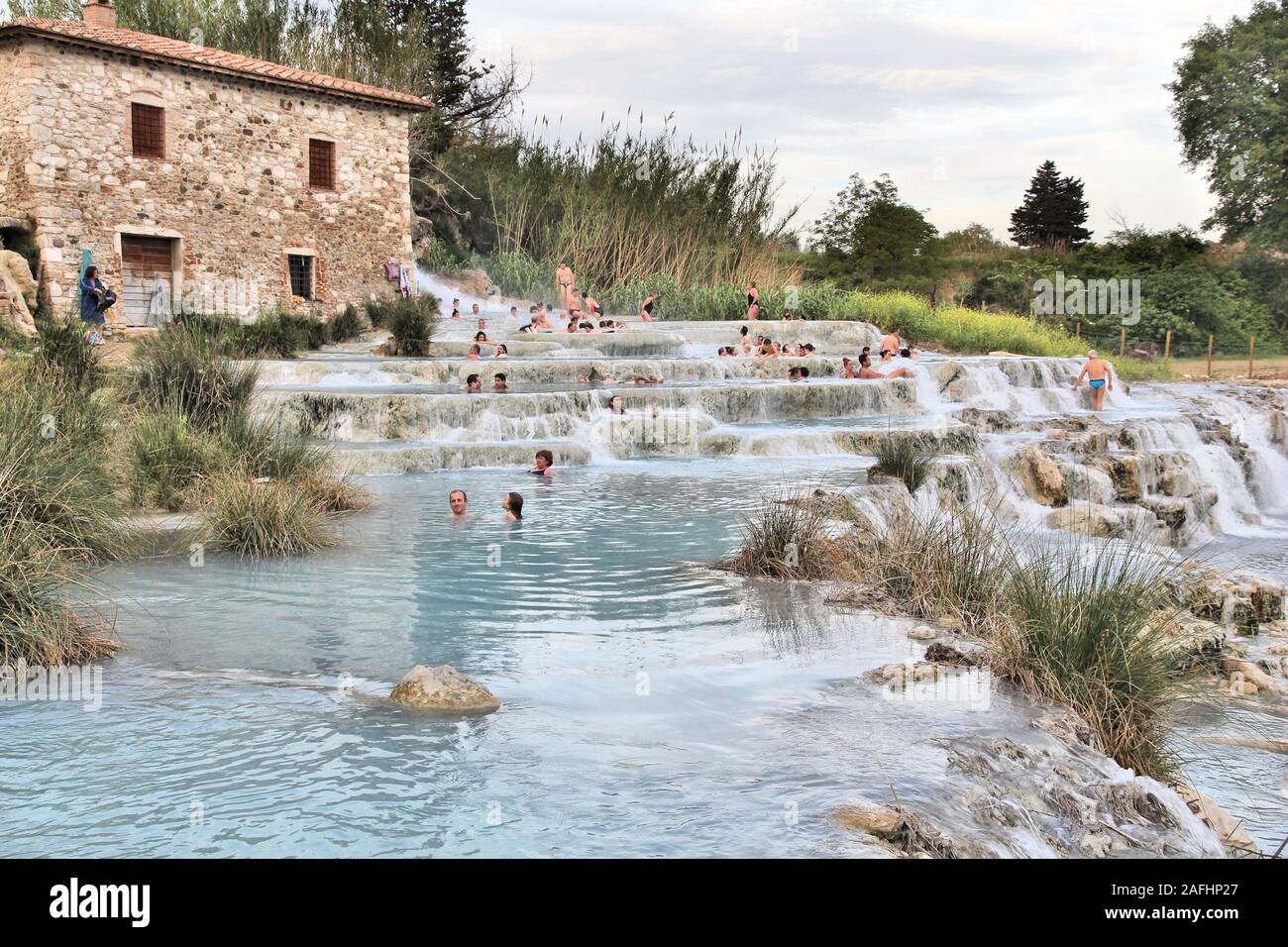 SATURNIA, ITALY - MAY 3, 2015: People visit natural hot springs in ...
