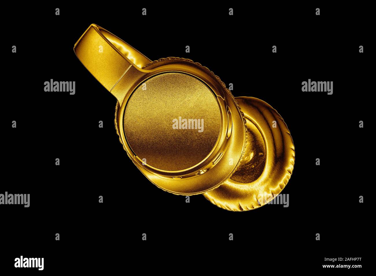 Golden shiny wireless headphones on black background isolated close up ...