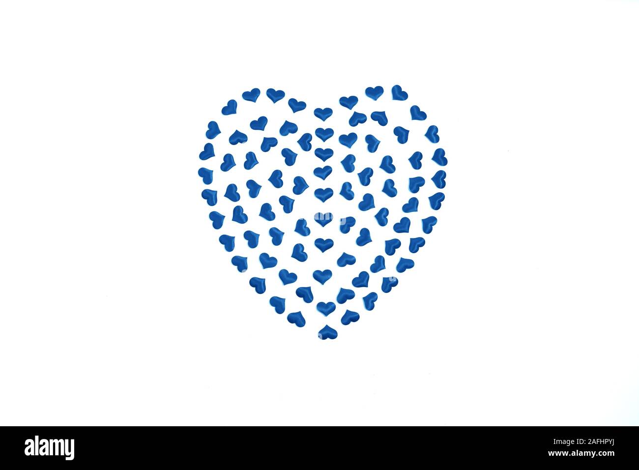 One blue big heart made up of many little hearts inside on white ...