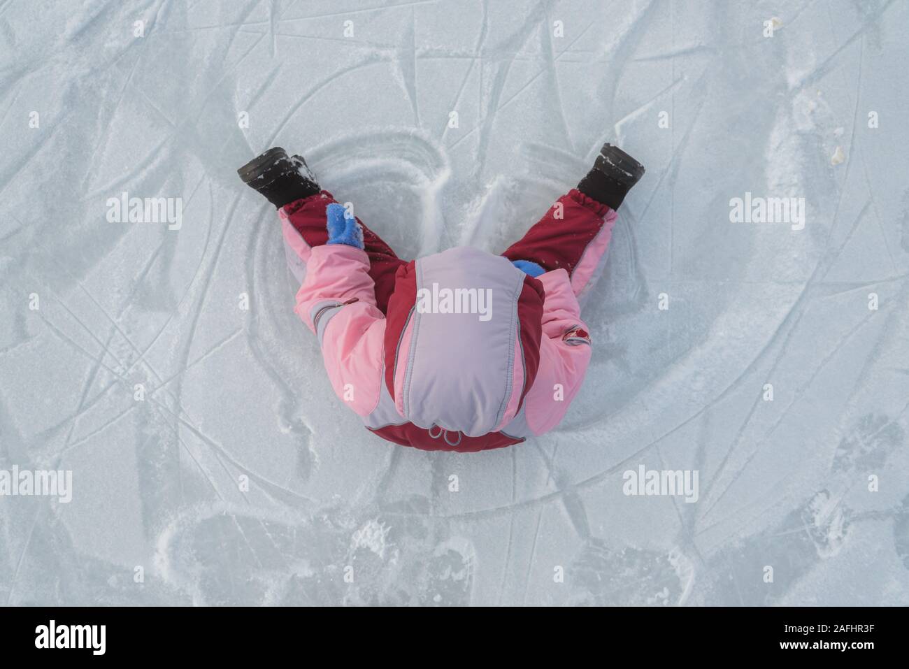little child is sitting on the ice in winter Stock Photo - Alamy