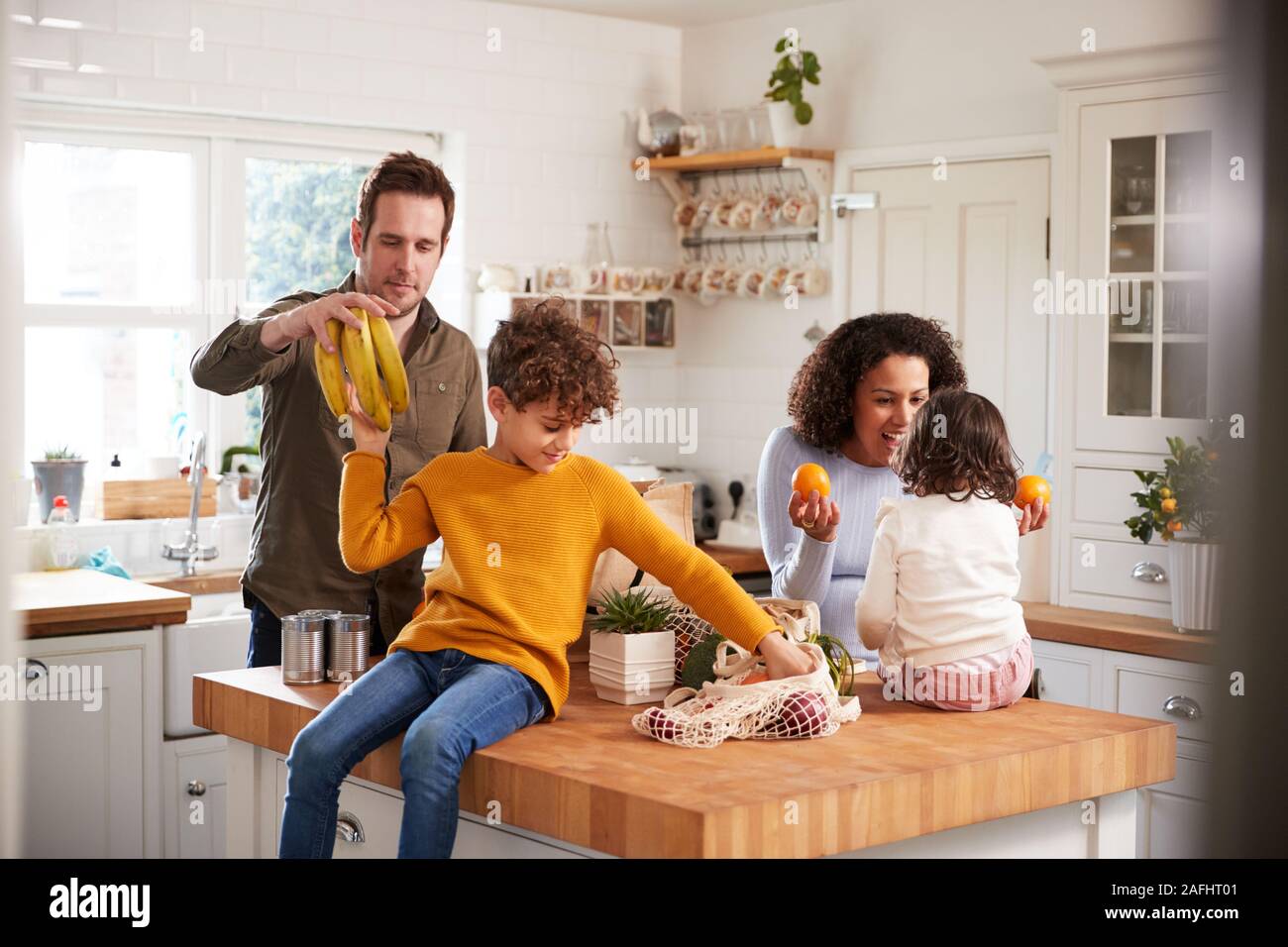 Family unpacking groceries in kitchen hi-res stock photography and ...