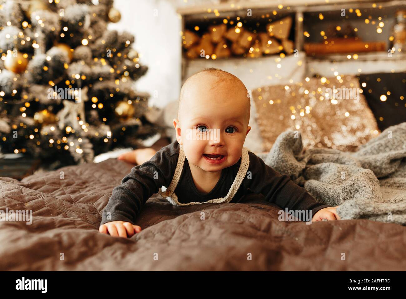 happy little child with Christmas tree and lights Stock Photo - Alamy