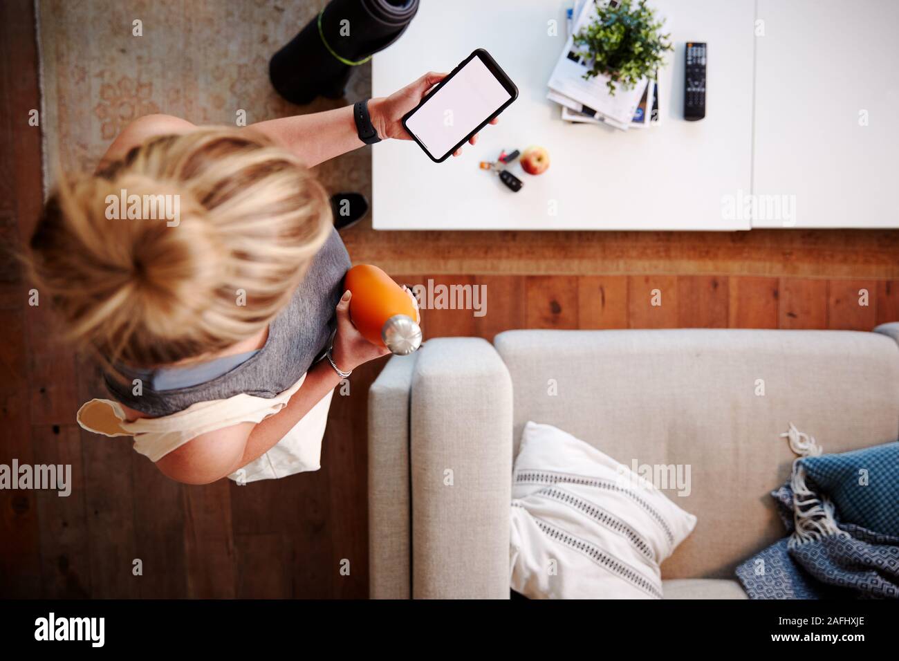 Overhead Shot Looking Down On Woman At Home Checking Phone Message ...