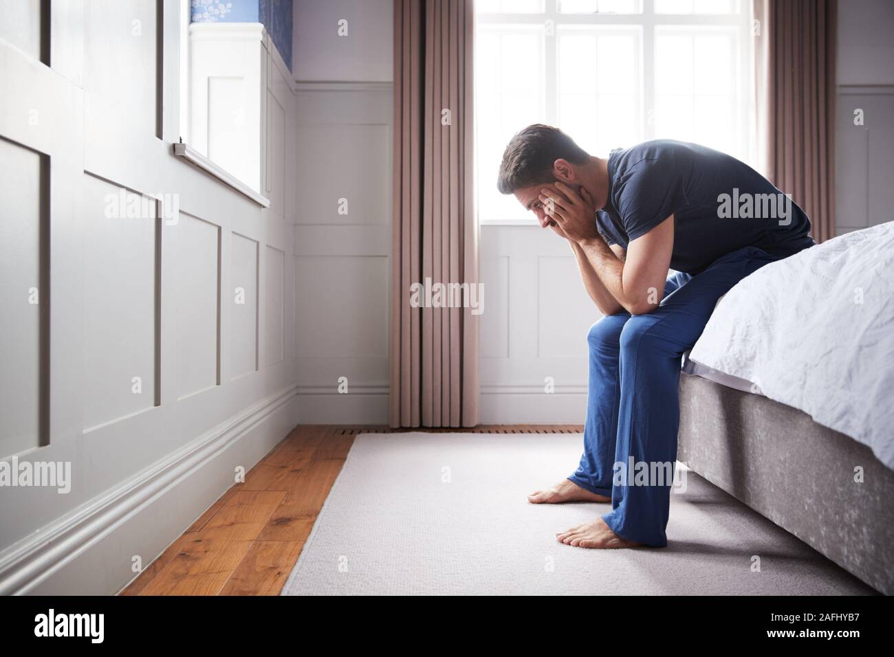 Sad man sitting hi-res stock photography and images - Alamy