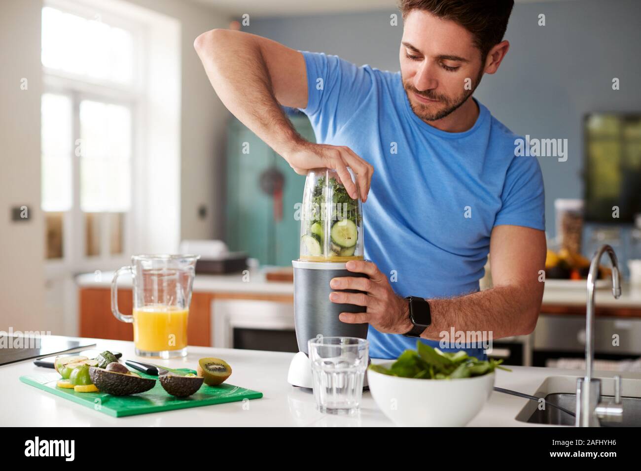 Man Making Healthy Juice Drink With Fresh Ingredients In Electric ...