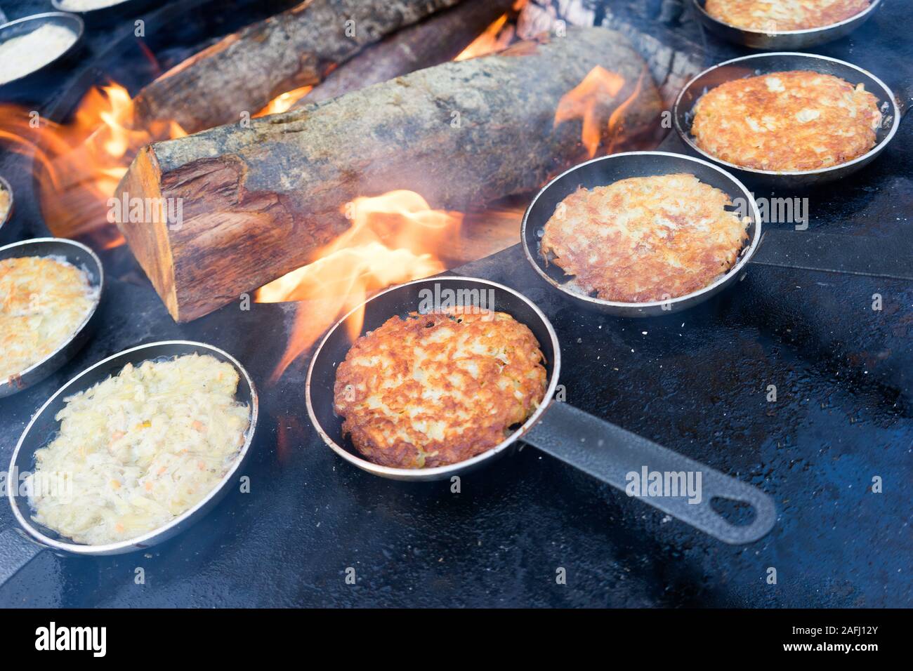 Pellets in a frying pan by the fire Stock Photo - Alamy