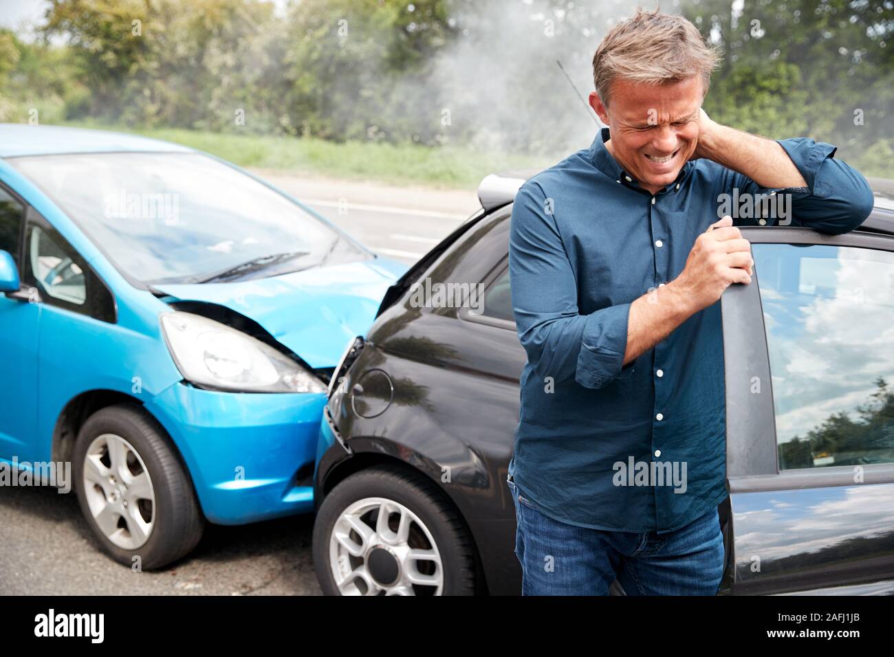 Mature Male Motorist With Whiplash Injury In Car Crash Getting Out Of ...