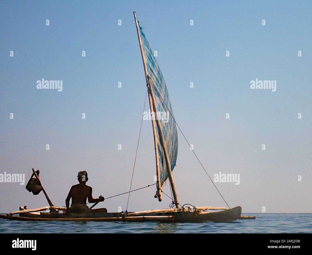 Indonesia Alor - local fisherman in outrigger sailing boat Stock Photo ...