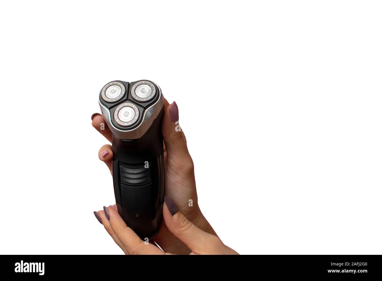 Female hands hold a male electric razor on a white isolated background ...
