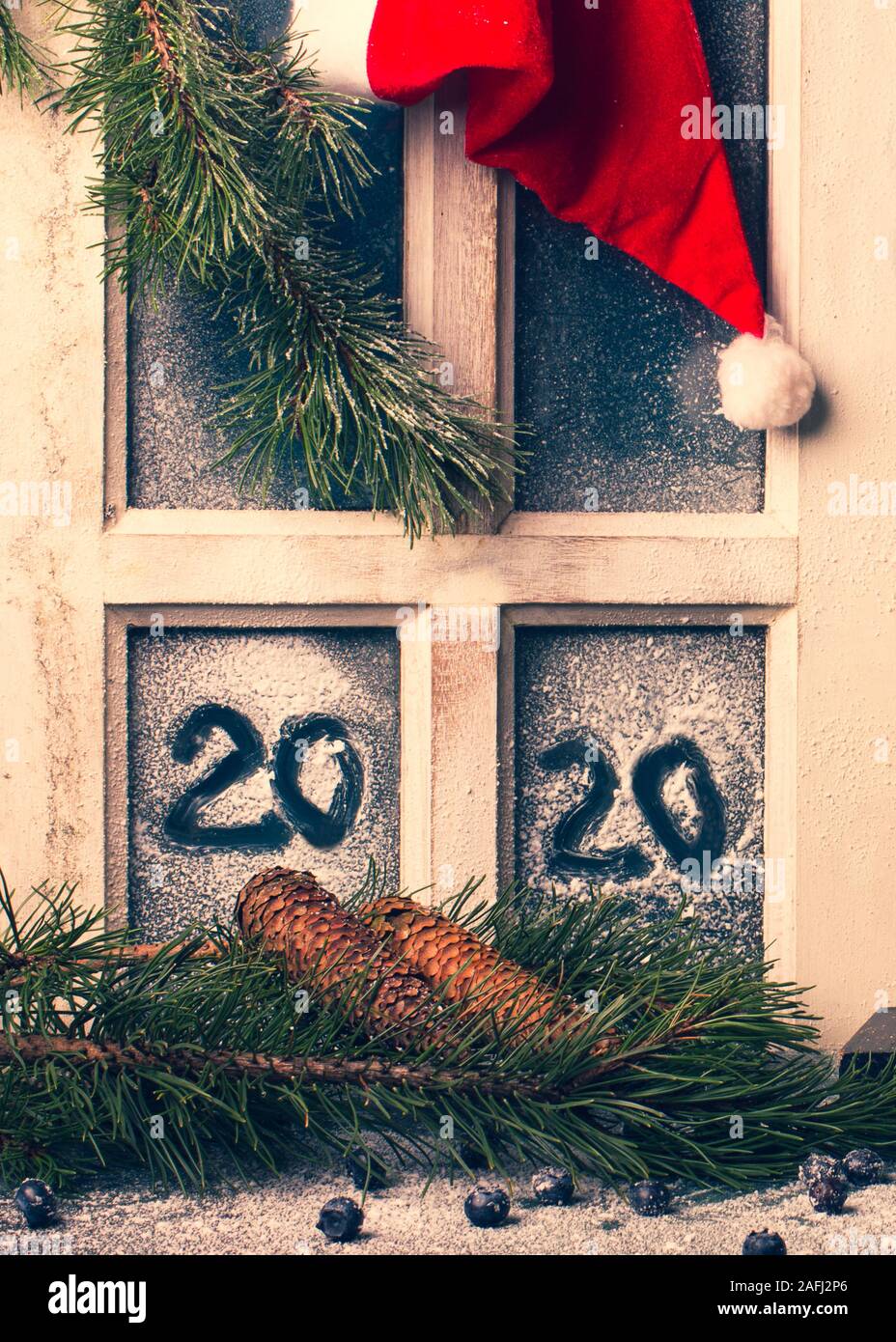 2020 numbers are drawn by hand on a snowy window. Happy 2020 New Year ...
