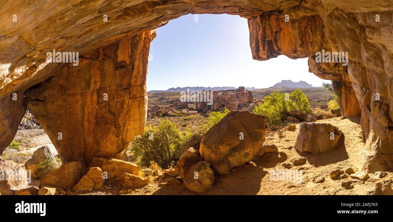 Panorama in a cave with view to mountains and bizarre rock formation ...