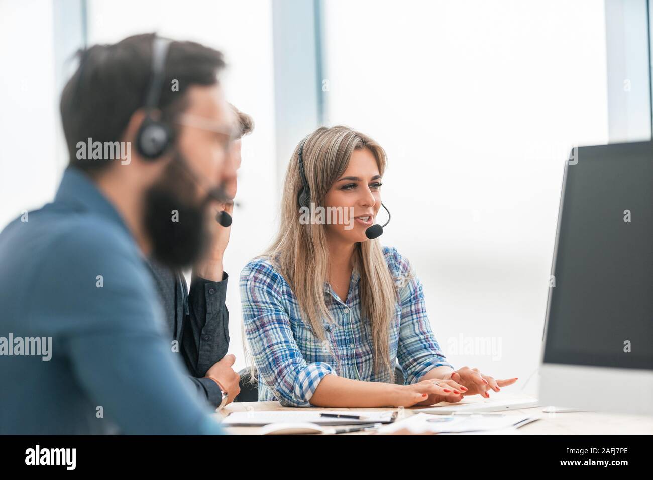 close up. young employees in the headset in the workplace Stock Photo ...