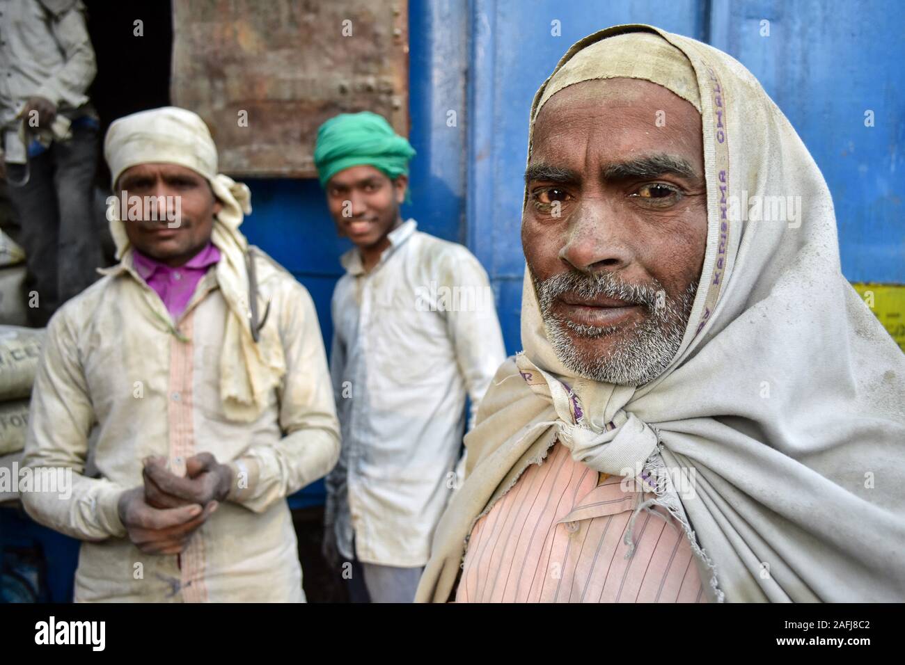 Punjab, India. 16th Dec, 2019. Indian labourers pose for a photo after ...