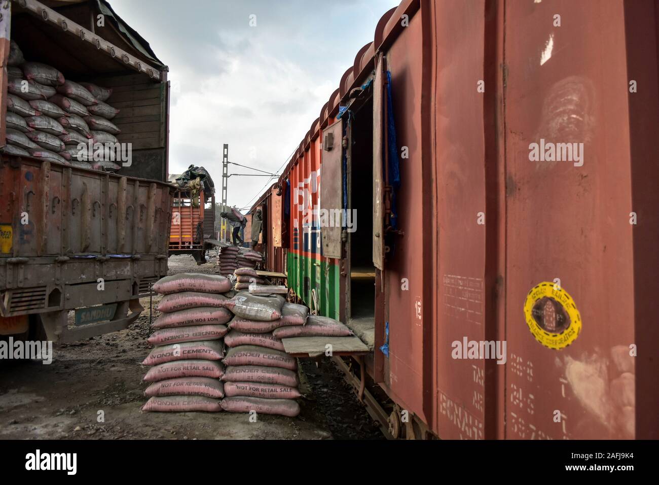 View of cement bags being unloaded from freight trains onto a truck at ...