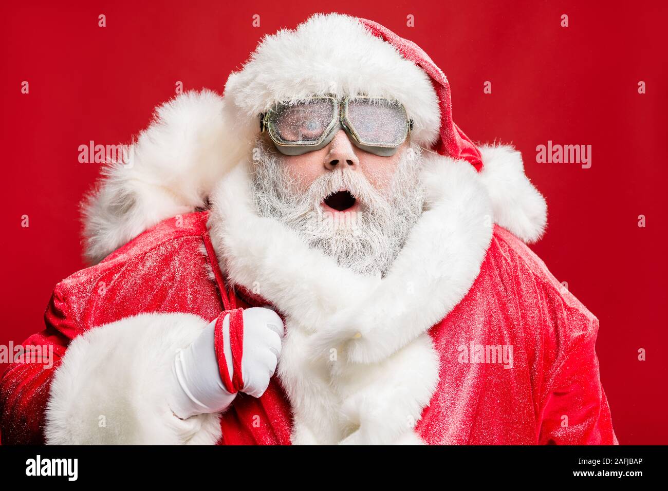 Close up photo of impressed elderly fun santa carry bag sack deliver ...