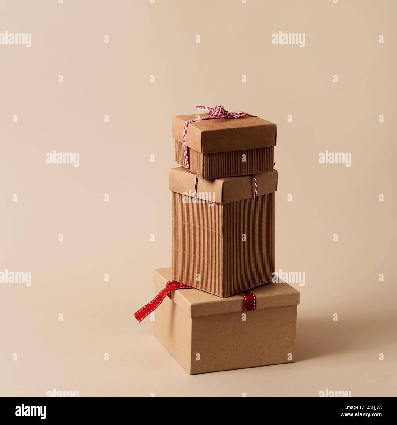 a pile of brown gift boxes tied with different strings and ribbons, on ...