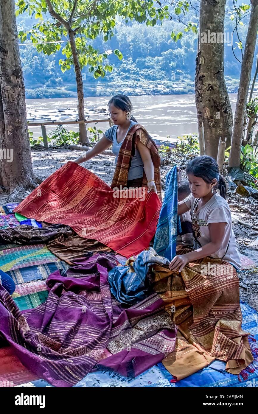 Preparing cloth for market, Laos Stock Photo - Alamy