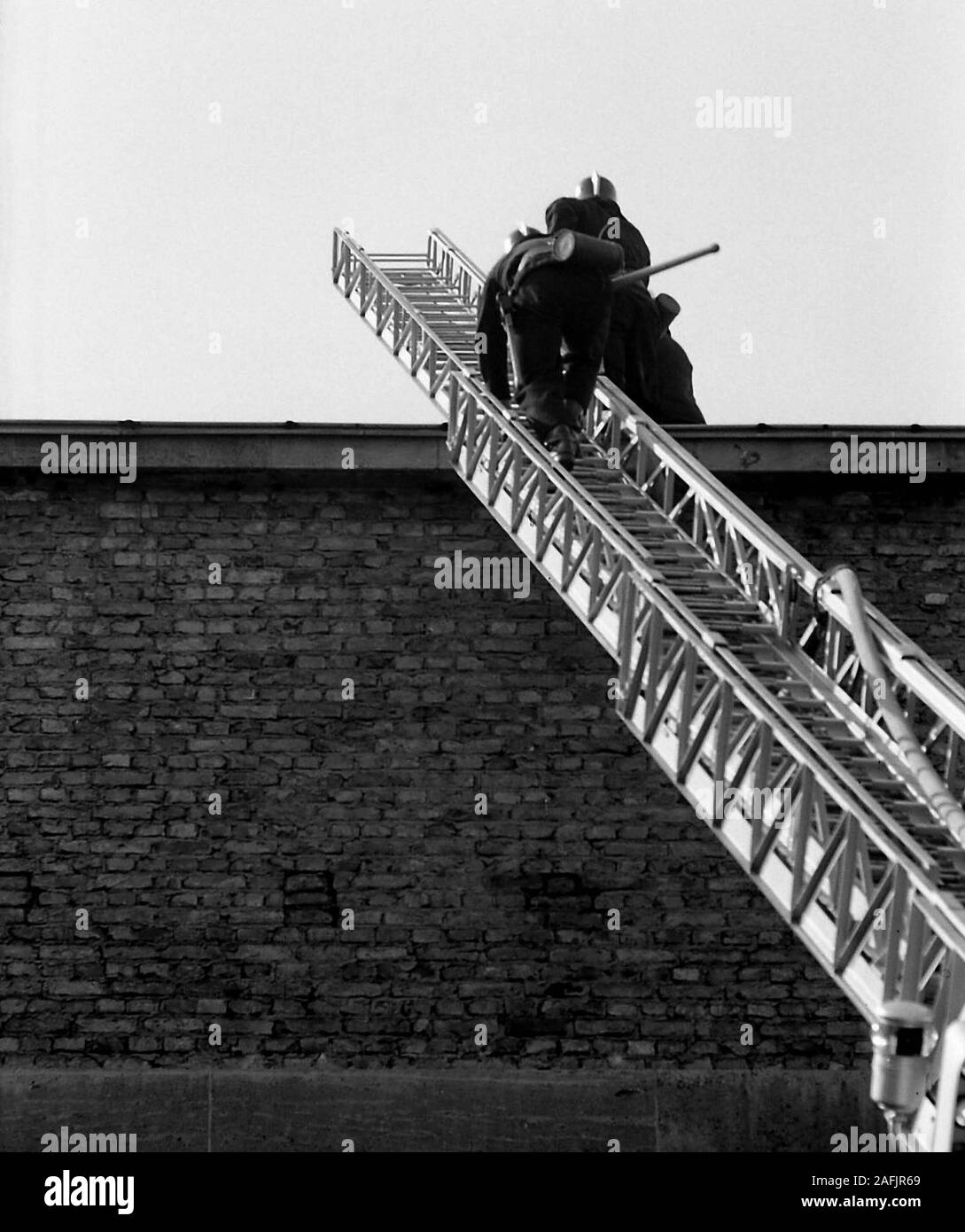 Climbing the ladder ladder Black and White Stock Photos & Images - Alamy