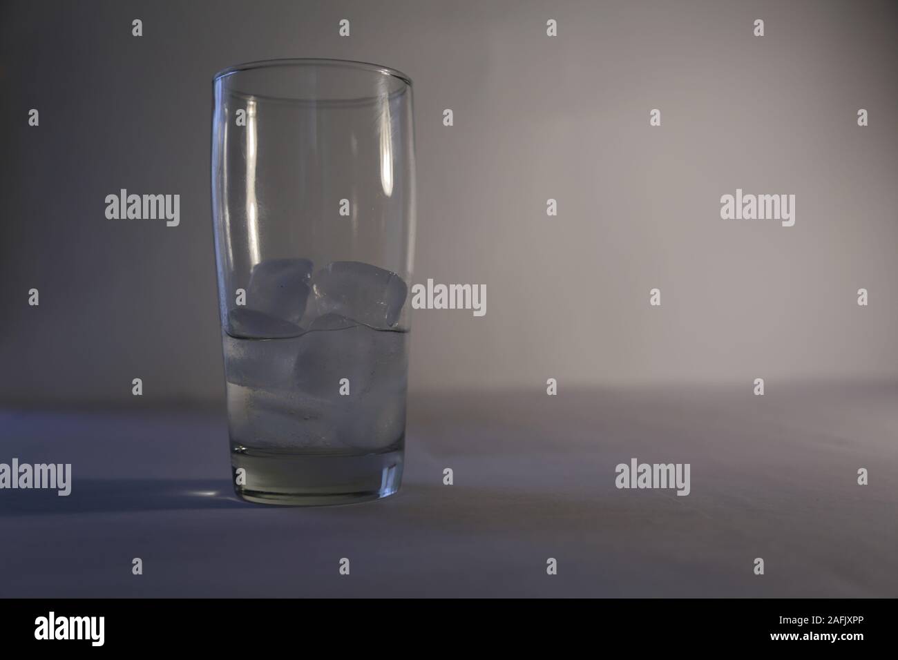 Glass with half melted ice Stock Photo - Alamy