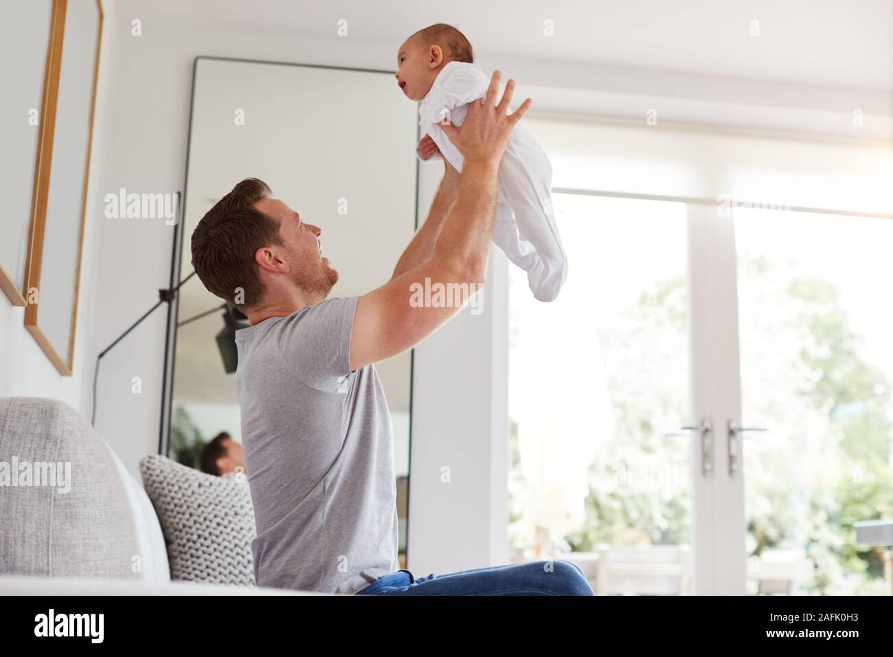 Father lifting baby daughter in hi-res stock photography and images - Alamy