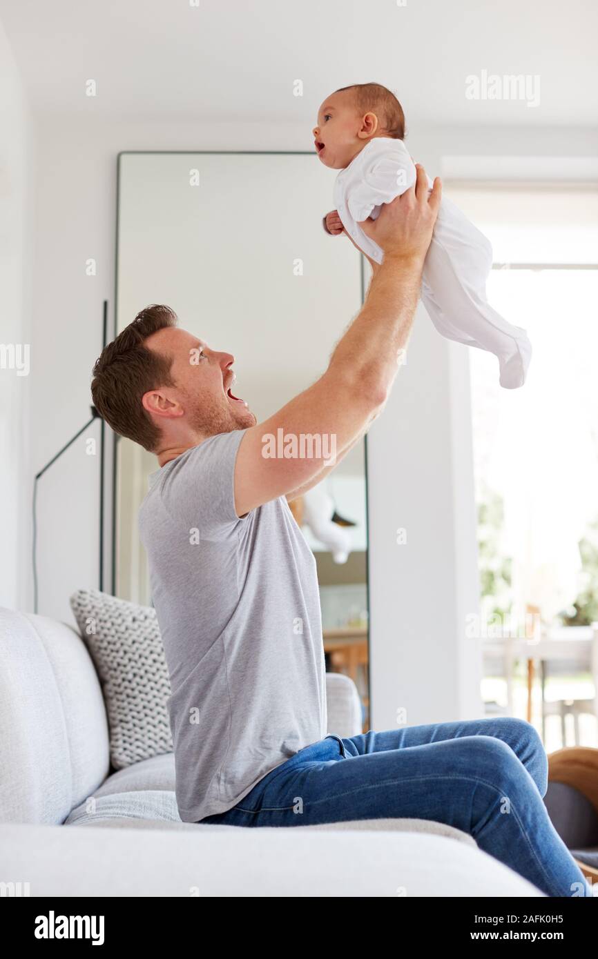 Father lifting baby daughter up hi-res stock photography and images - Alamy