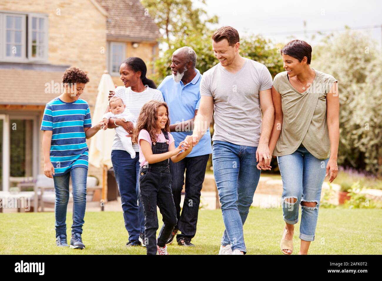 Smiling Multi-Generation Mixed Race Family In Garden At Home Together ...