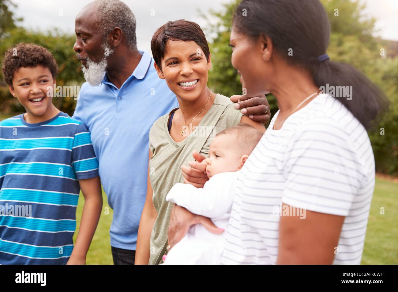 Smiling Multi-Generation Mixed Race Family In Garden At Home Together ...