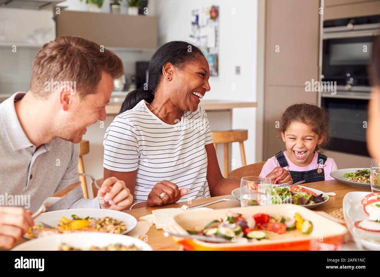 Multi generation family sharing meal together hi-res stock photography ...
