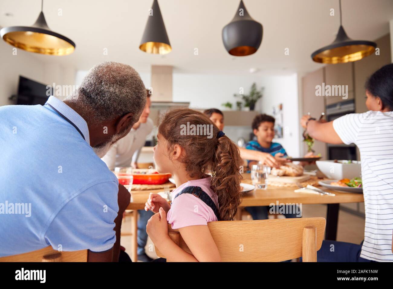 Multi generation family sharing meal together hi-res stock photography ...