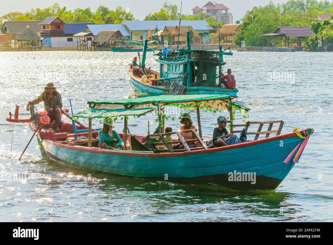 Ferry & fishing boat on the Praek Tuek Chhu River in this old French ...