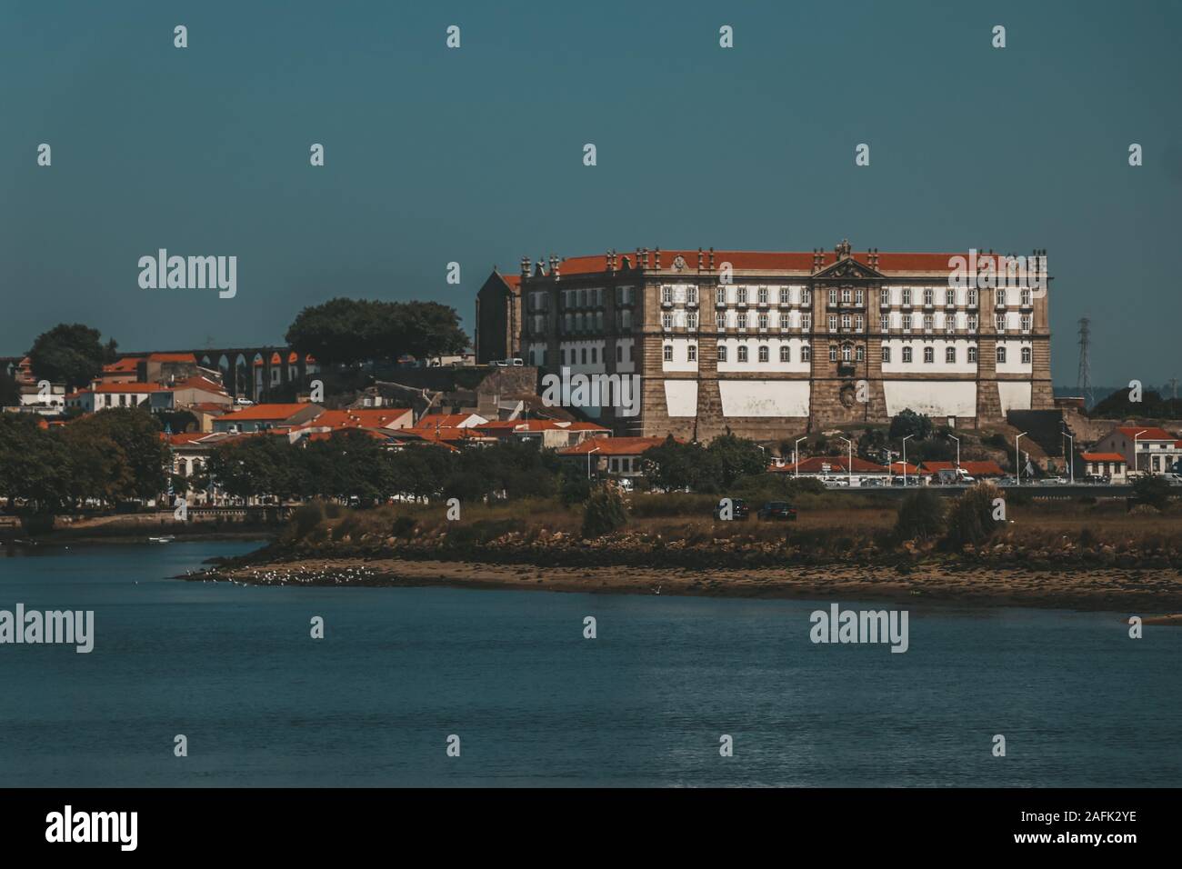 Riverside view of a small religious convent Stock Photo - Alamy