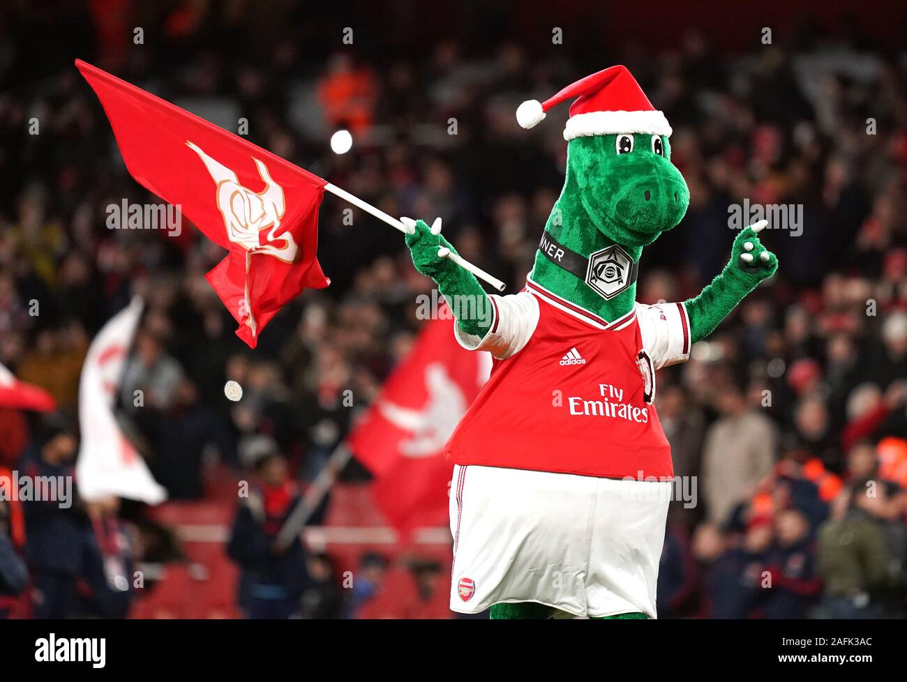 Arsenal's mascot Gunnersaurus shows their support Stock Photo - Alamy