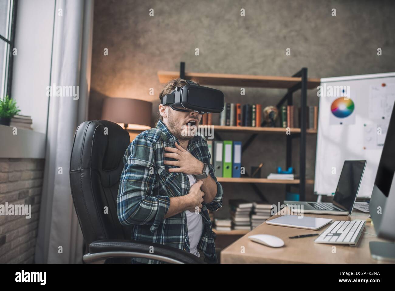 Man feeling scared while using VR headset Stock Photo - Alamy