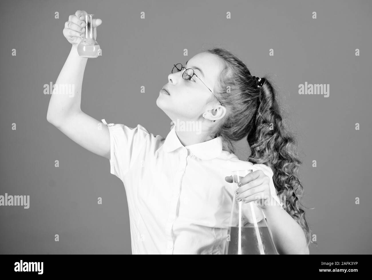 Scientific experiment. science research in lab. Small school girl ...