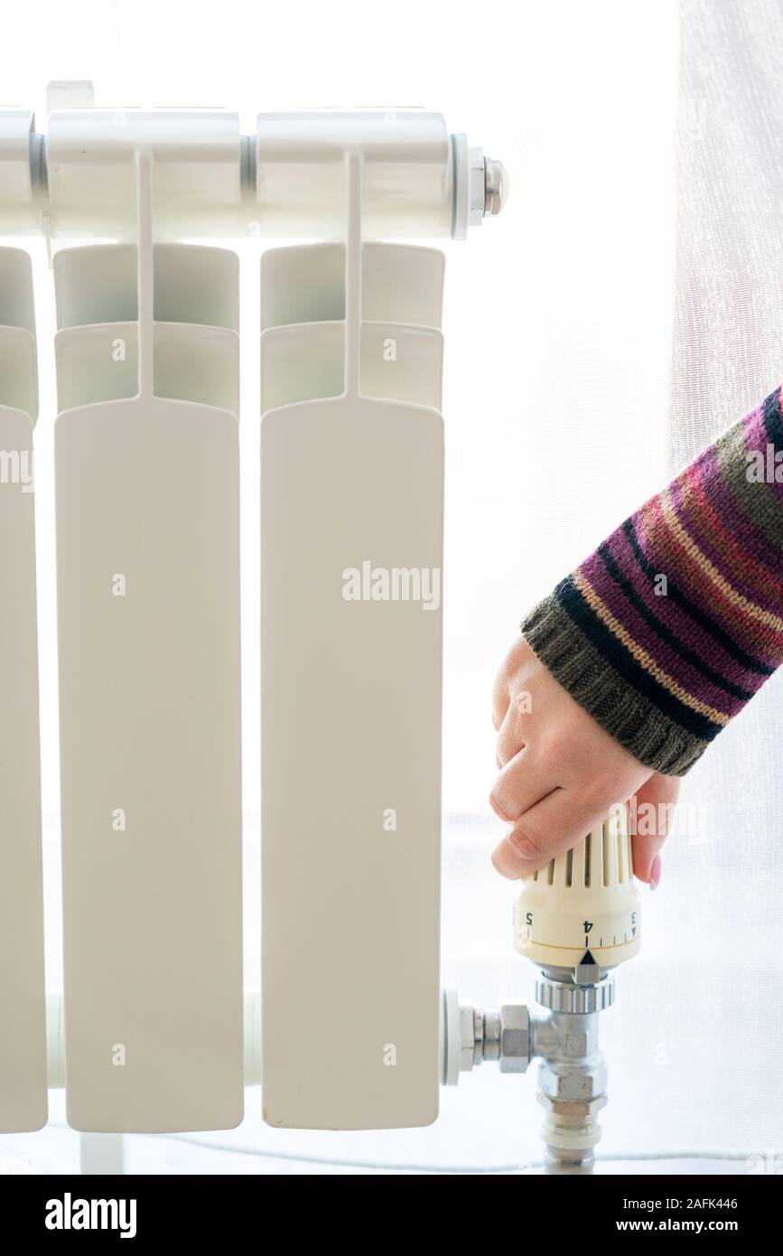 Radiator adjustment closeup, Female hand adjusting radiator temperature ...