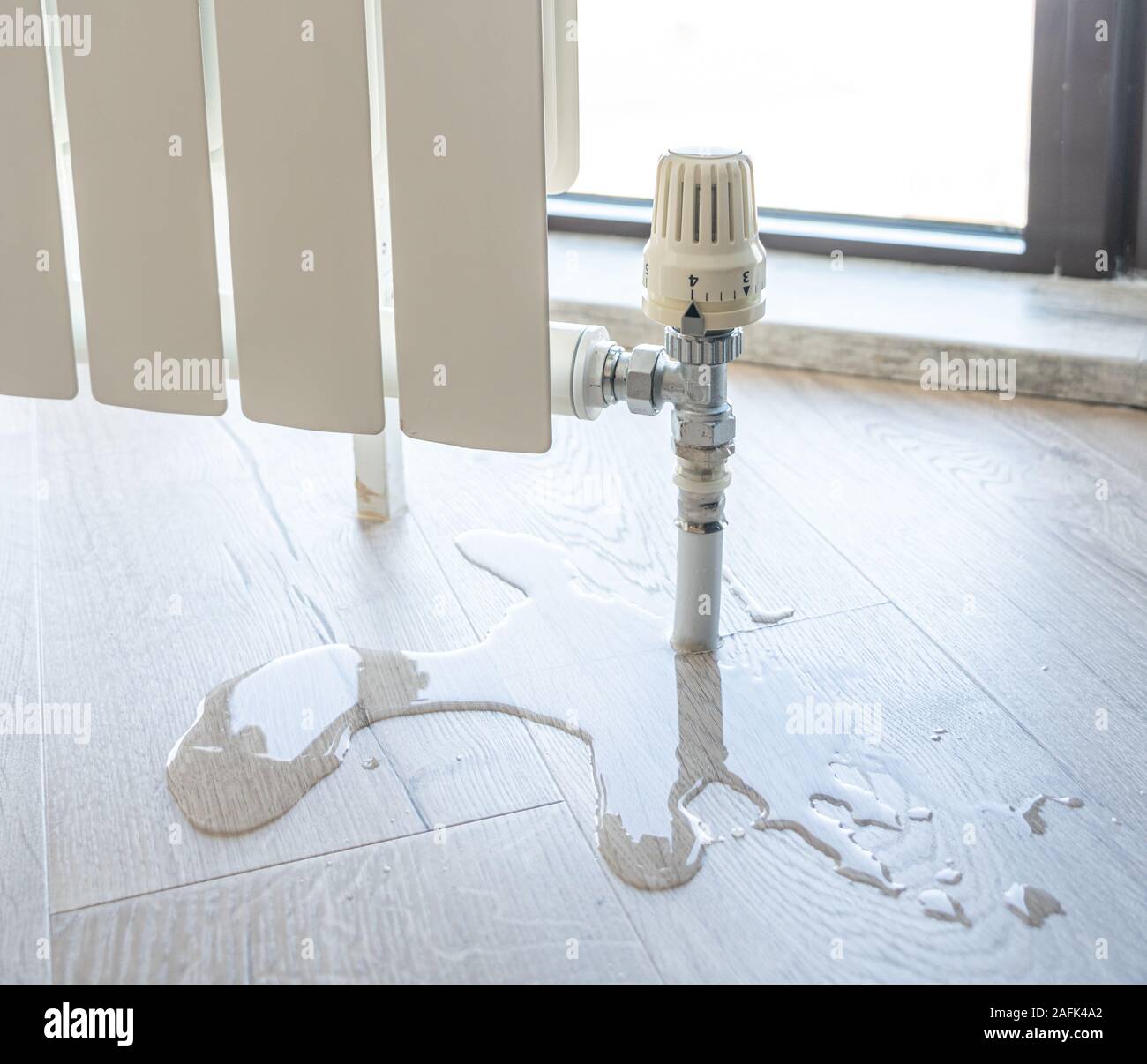 water leak through the heating radiator tube nut Stock Photo - Alamy