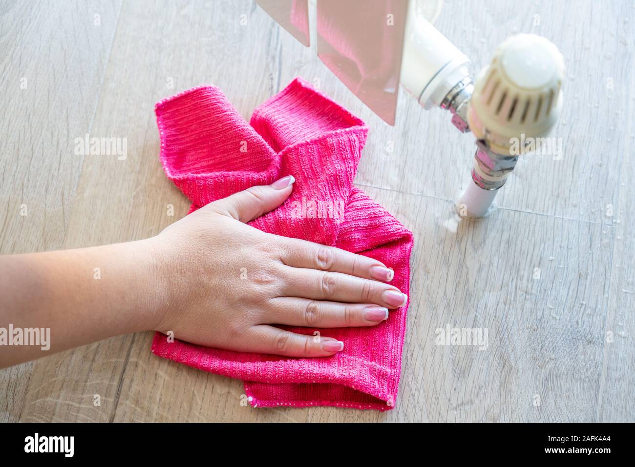Female hand with rag cleaning water from heating radiator Stock Photo ...