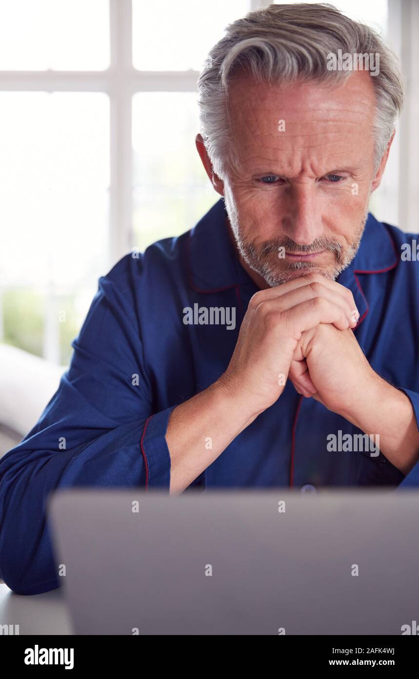 Serious Mature Man Looking Up Information Online Using Laptop Stock ...