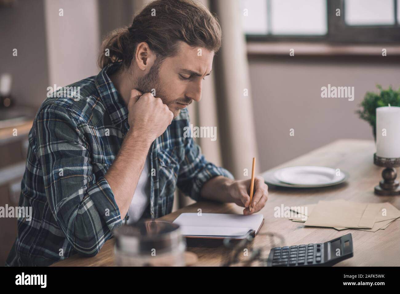 Young man creating a project of his own business Stock Photo - Alamy
