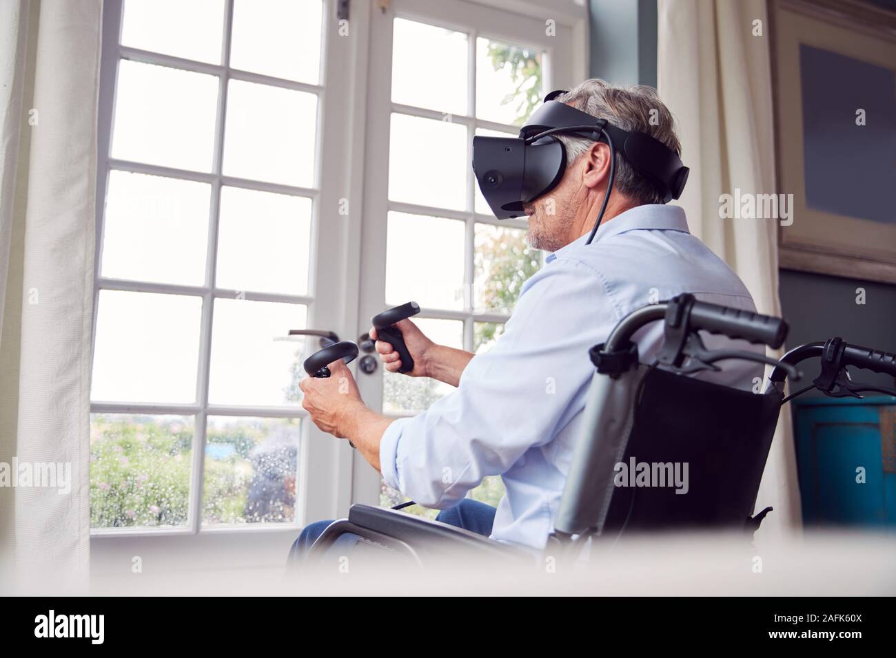 Mature Disabled Man In Wheelchair At Home Wearing Virtual Reality ...