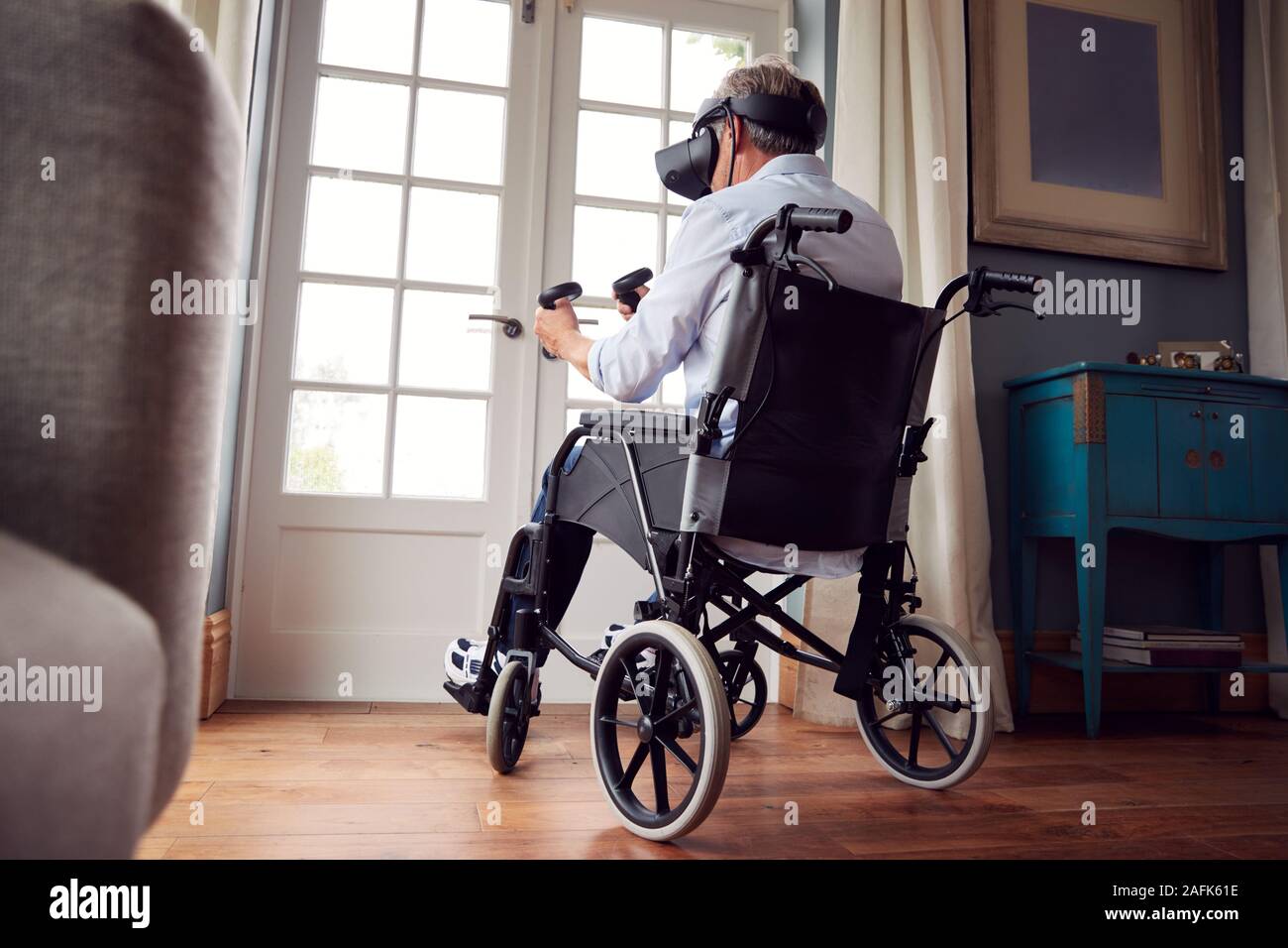 Playing computer game in wheelchair hi-res stock photography and images ...