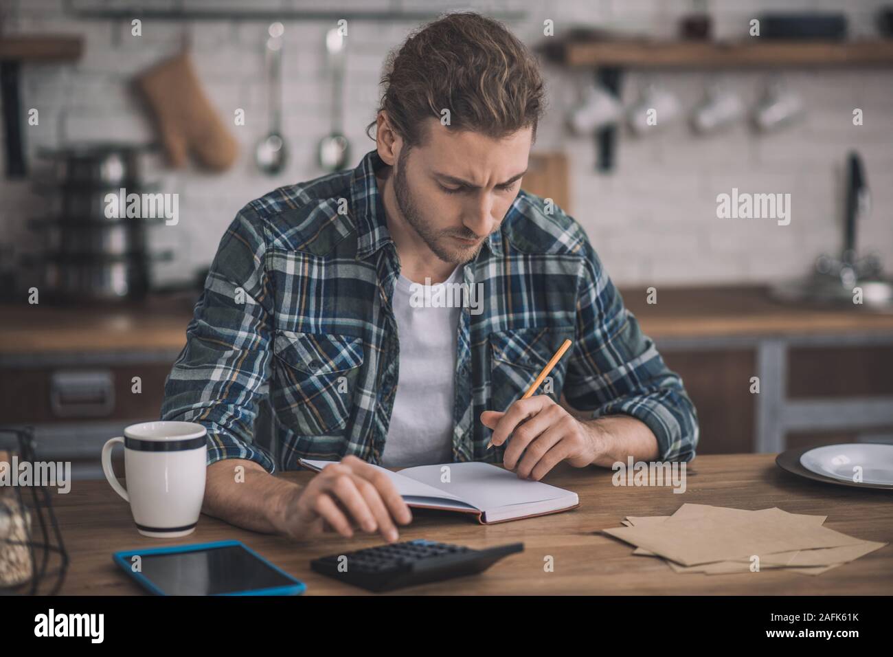 Thoughtful bearded man writing hi-res stock photography and images - Alamy