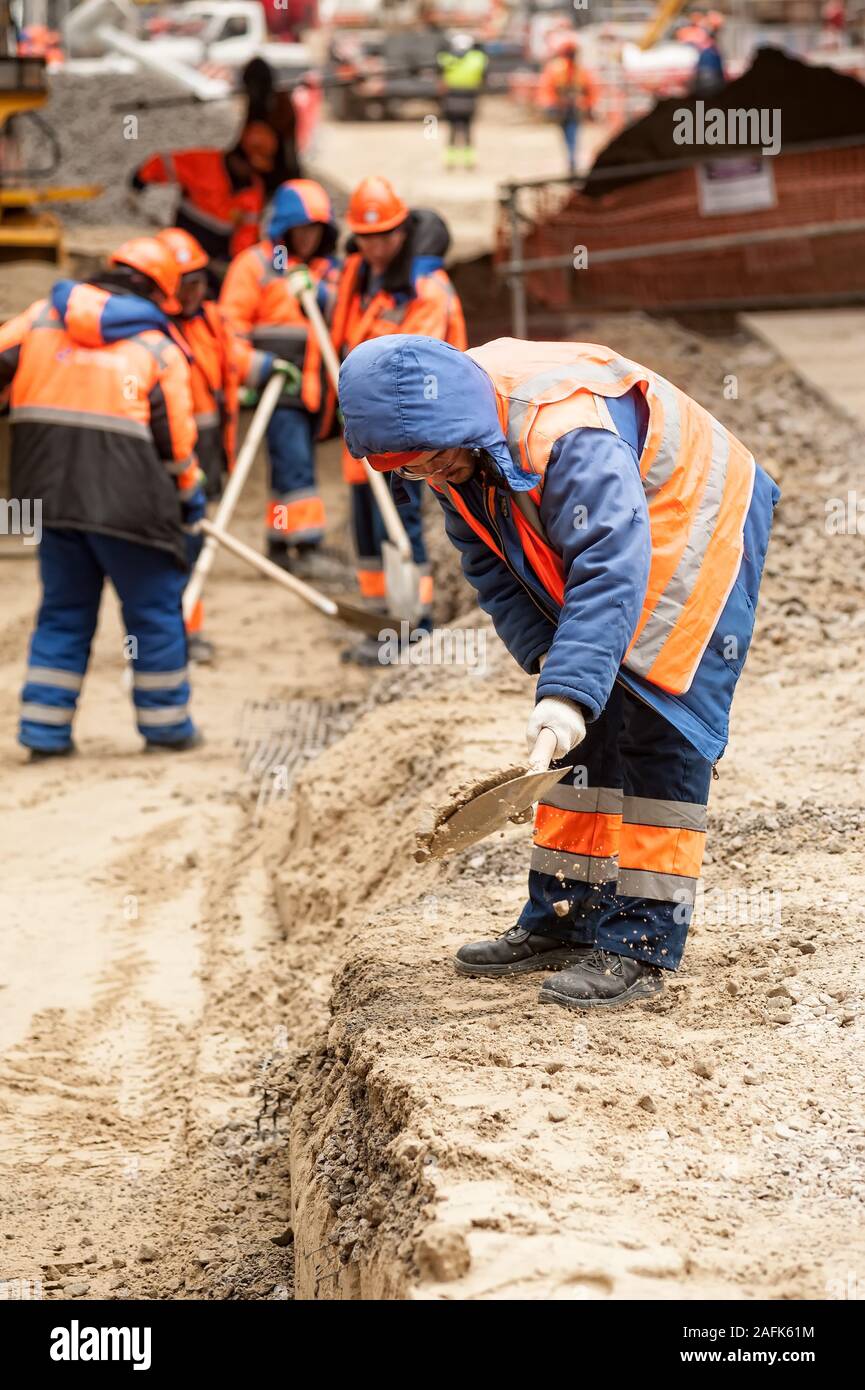 Construction workers with a shovel Stock Photo - Alamy
