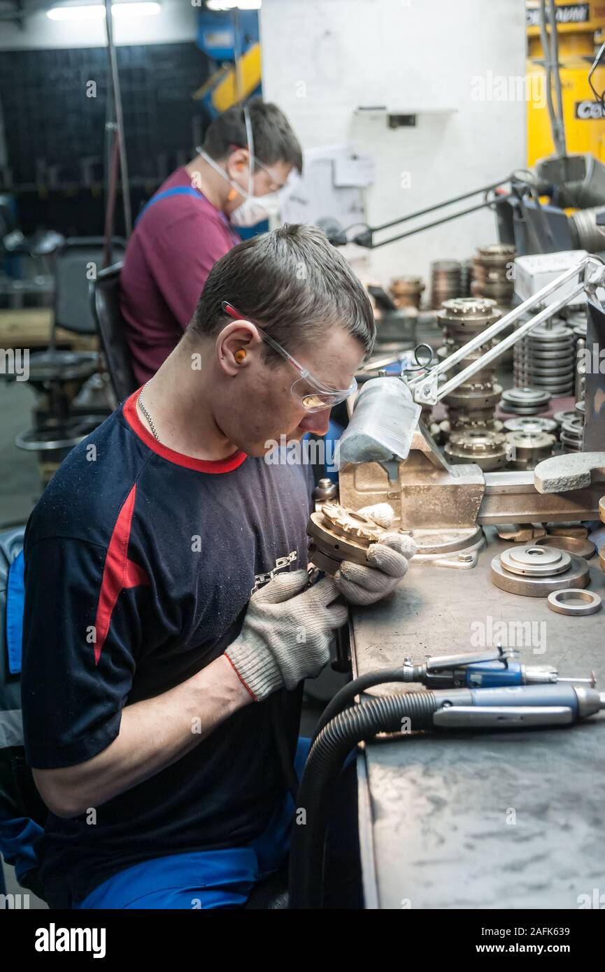 Mechanic gets into condition for filling of bottle Stock Photo - Alamy