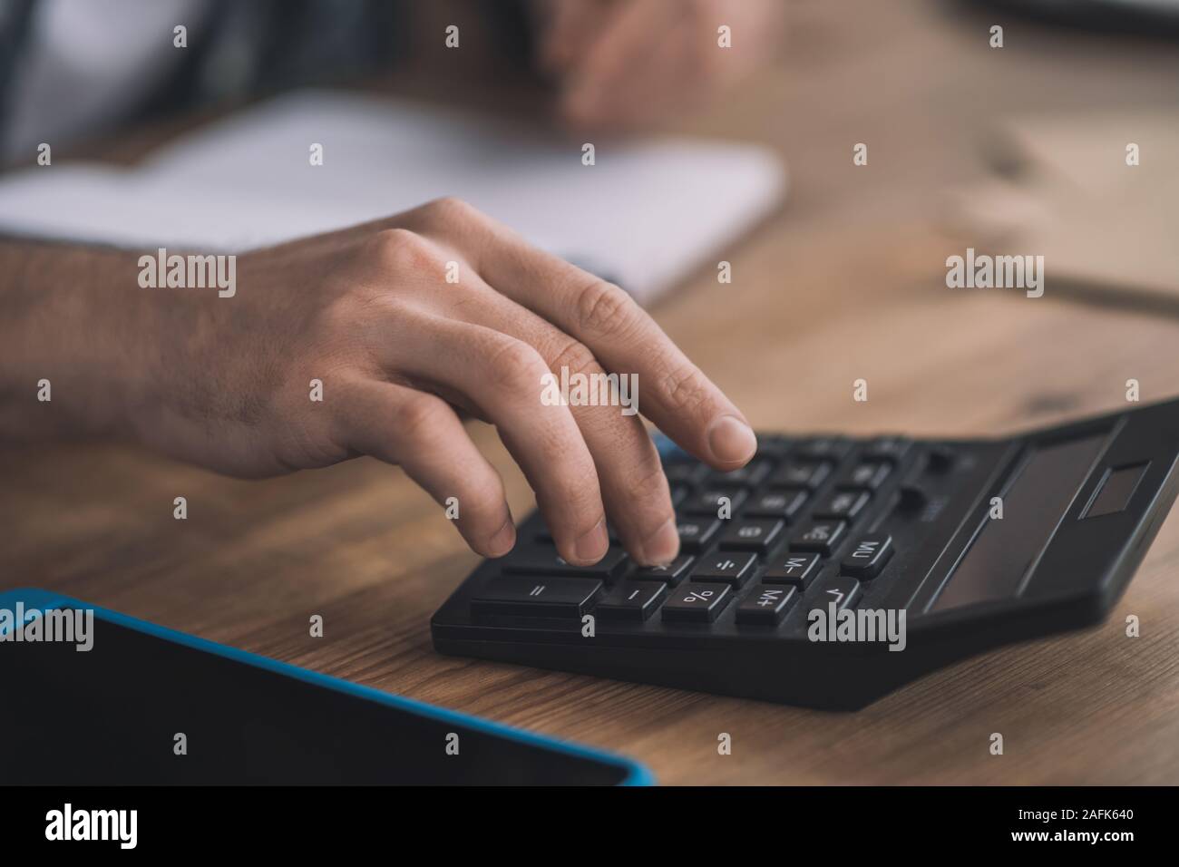 Man using the calc for accounting calculations Stock Photo - Alamy