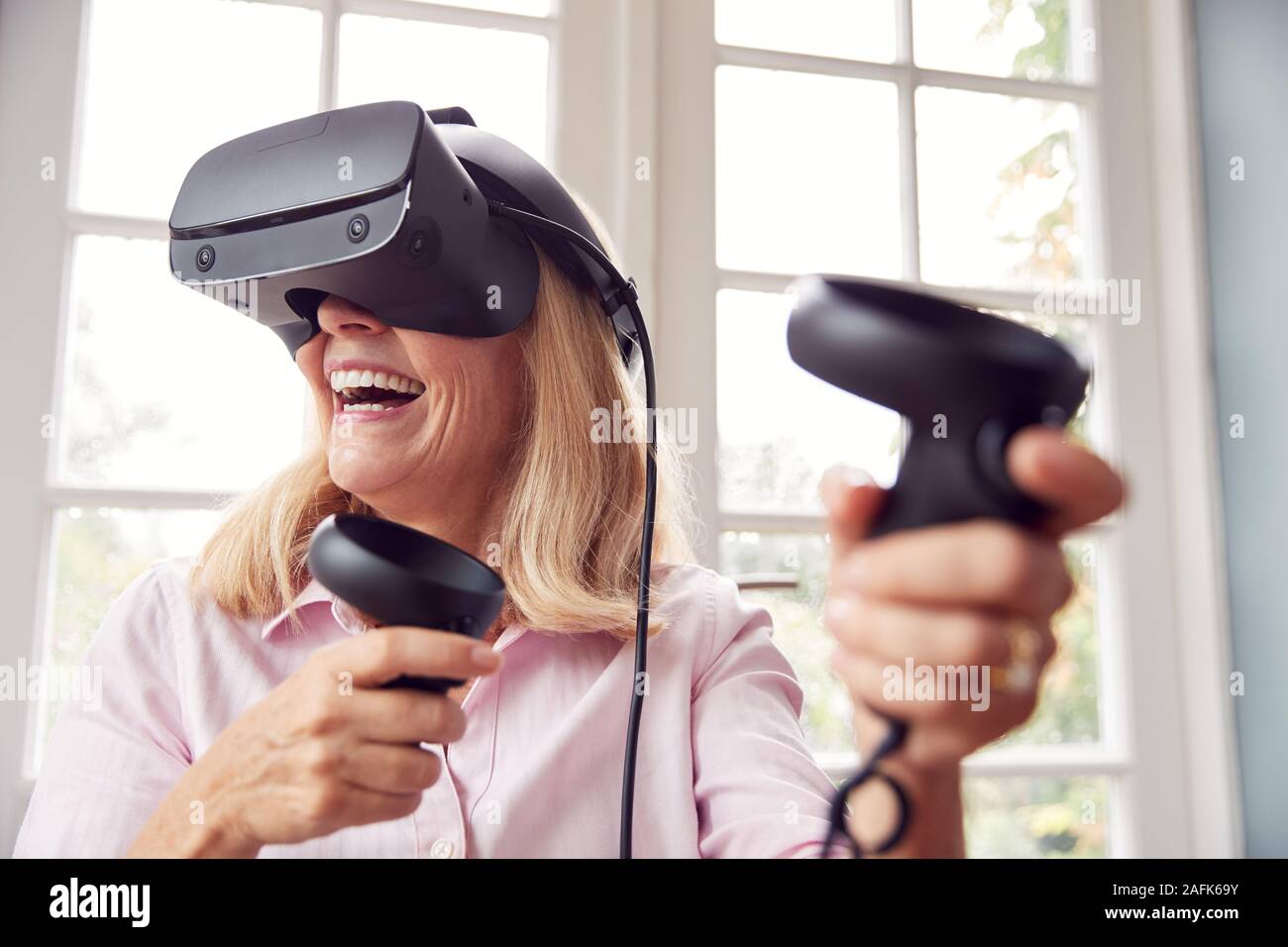 Mature Disabled Woman In Wheelchair At Home Wearing Virtual Reality ...